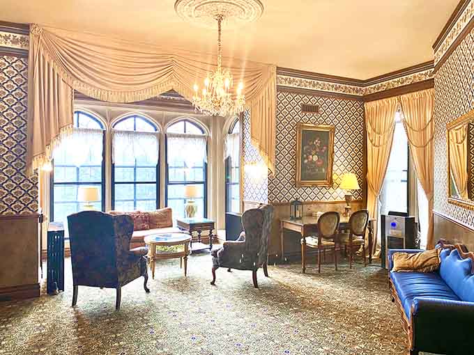 Chandeliers, patterned wallpaper, and velvet chairs create the kind of elegance your living room secretly envies.