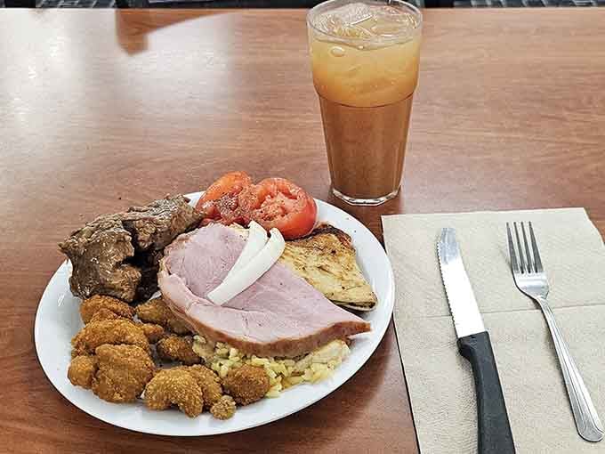 Carved ham, collard greens, and a yeast roll—this plate understands what comfort food really means.