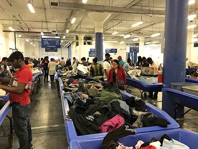 Serious shoppers work the bins with the focus of archaeologists excavating for designer labels and hidden gems.