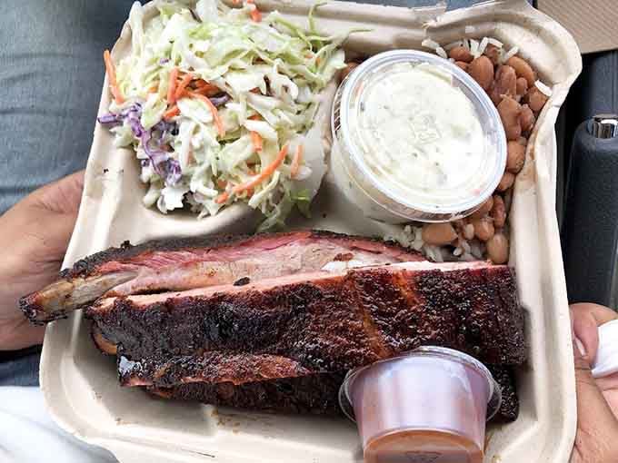 This platter proves that beans, slaw, and ribs together create harmony that would make any choir jealous.