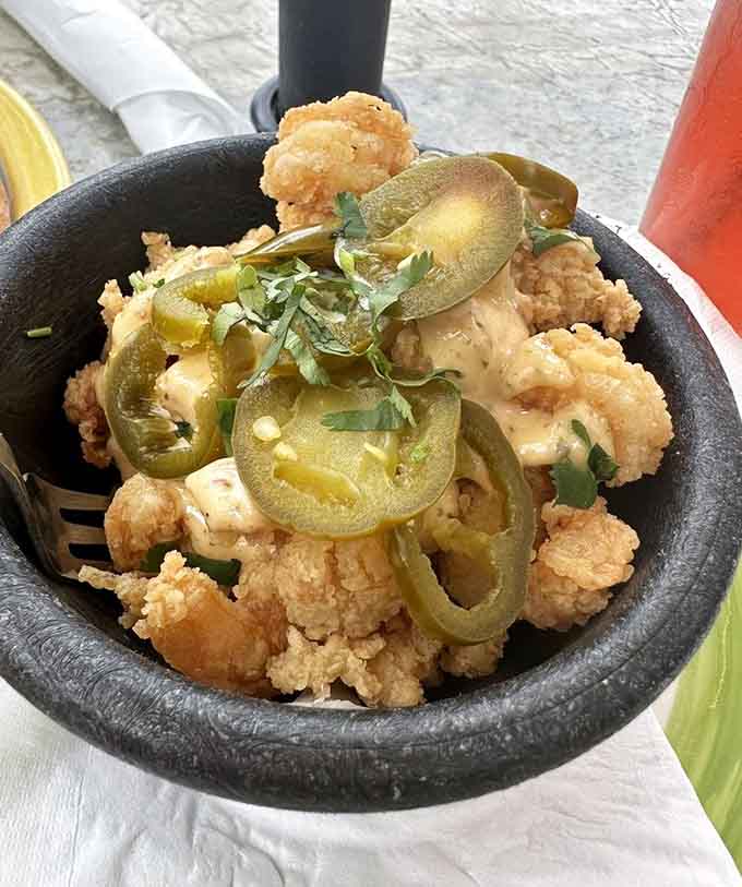 Spicy shrimp in a cast iron skillet with jalapeños, proving that good things come in hot packages.