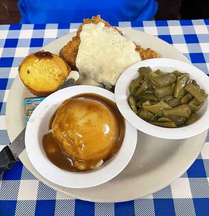Country fried steak smothered in gravy, the kind of plate that makes you loosen your belt preemptively.