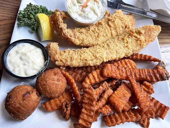 Golden fried catfish with hushpuppies and waffle fries proves Kentucky knows how to do seafood inland.