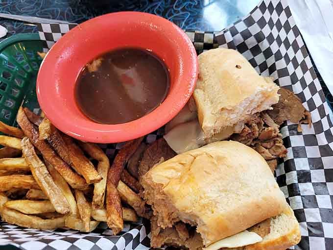 French dip sandwich with au jus for dunking, proving that sometimes the best meals require a little hands-on participation.