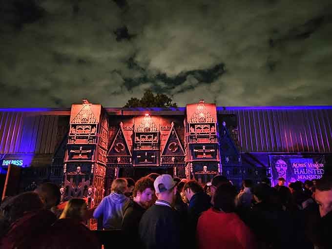 The crowd gathers beneath ominous facades, united in their collective decision to pay for psychological trauma tonight.