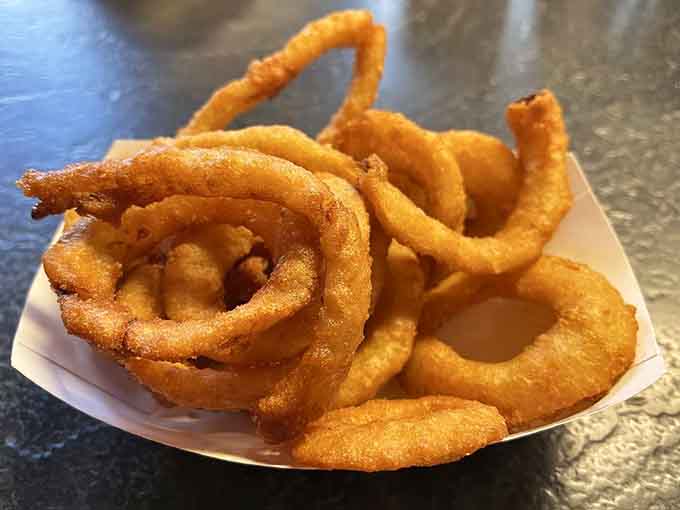 Golden onion rings so perfectly crispy they could make a grown person weep tears of pure joy.