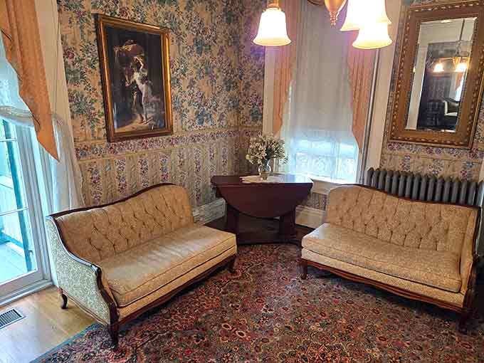 Matching settees face each other like they're waiting for guests who may or may not still be breathing to arrive.