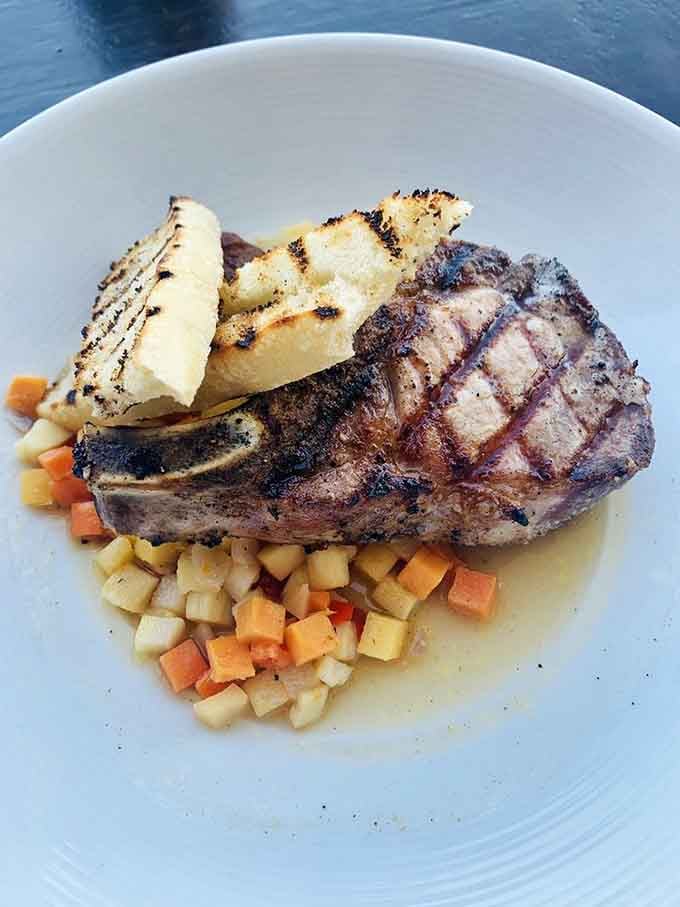 That pork ribeye with its beautiful char marks looks like it graduated summa cum laude from grilling school.