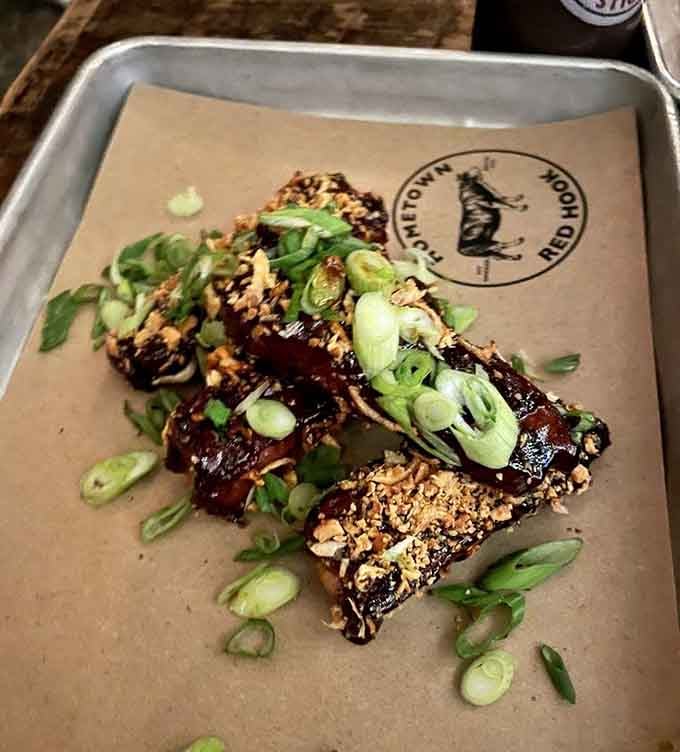 Korean sticky ribs topped with scallions and sesame bring international flair to traditional barbecue with delicious results.