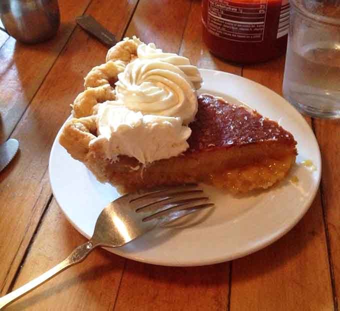 Salted honey pie with its fluted crust and swirled cream topping, basically edible architecture on a rustic table.