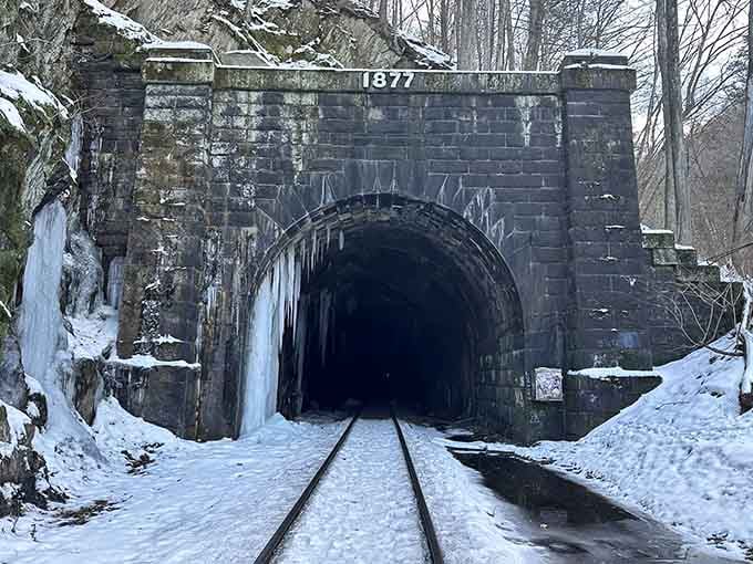 Winter transforms the tunnel entrance into something from a Dickens novel, minus the happy ending for many workers.
