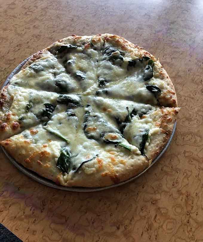 The White Flag pizza proves that sometimes surrendering to ricotta and garlic is the smartest decision you'll make all day.