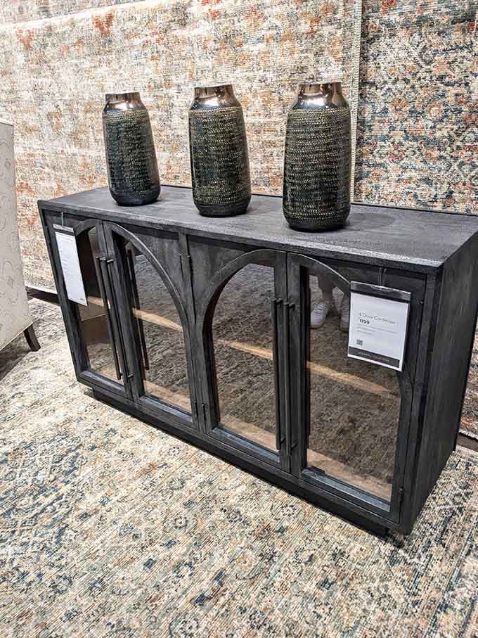 A credenza with glass doors and decorative vases, because your stuff deserves to look fancy too.