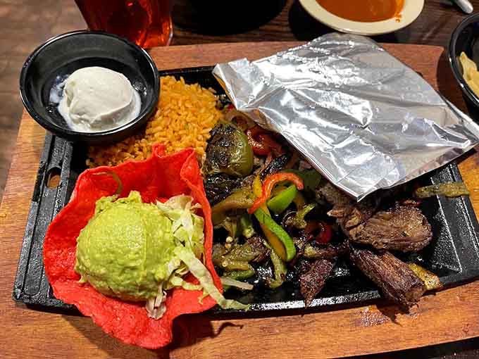 Sizzling beef fajitas arrive like a delicious thunderstorm, complete with peppers, onions, and enough guacamole to make you weep.