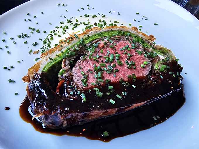 Perfectly seared beef with asparagus and rich sauce proves French technique translates beautifully to Alabama plates.