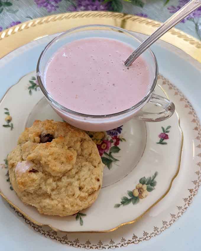 That pink beverage paired with a golden scone is basically a hug in edible form for your taste buds.