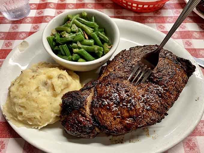 When your ribeye arrives with loaded mashed potatoes and green beans, you know you've hit the Texas jackpot tonight.