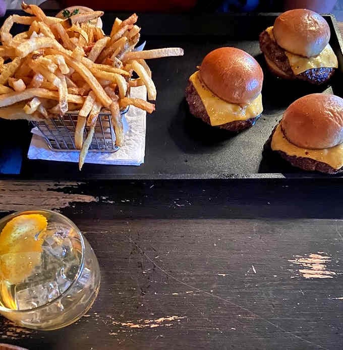Sliders and fries arrive like tiny burgers with big flavor, proving good things really do come in small packages.