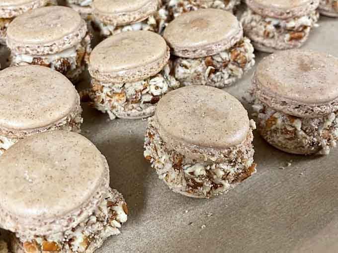 Carrot cake macarons with crushed pecans because someone finally understood what we've all been dreaming about.