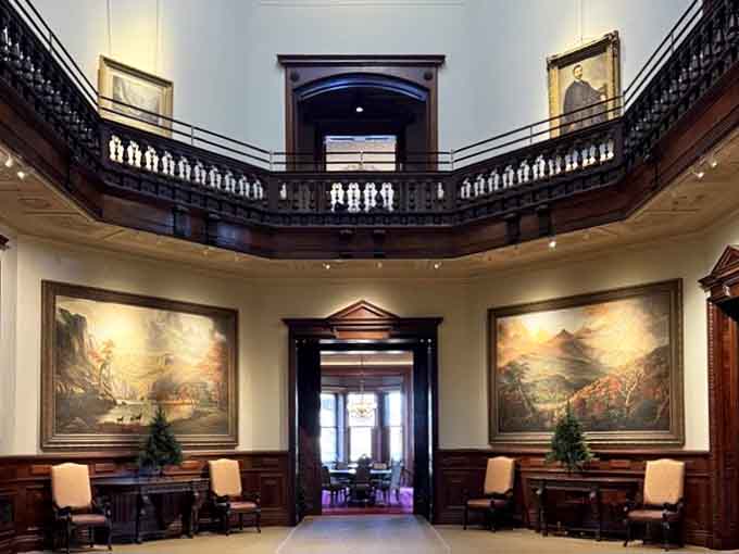 The soaring gallery space with those massive landscape paintings makes your living room gallery wall feel suddenly inadequate and apologetic.