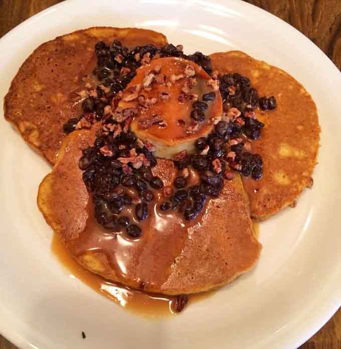 Pumpkin pancakes stacked high with berries and bacon make autumn last all year long, thankfully.