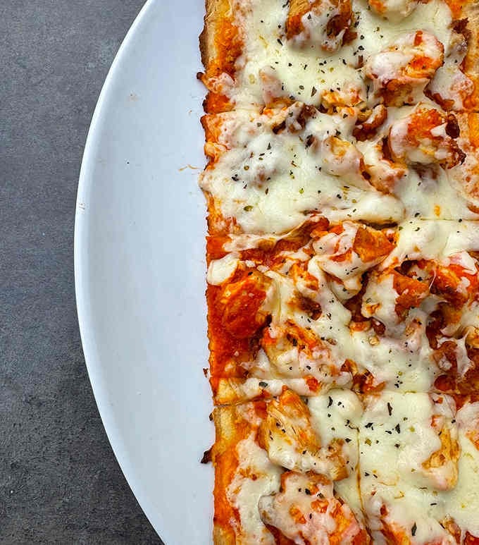 Boston-style pizza with enough cheese to make your cardiologist schedule an intervention, and you'll love every bite.