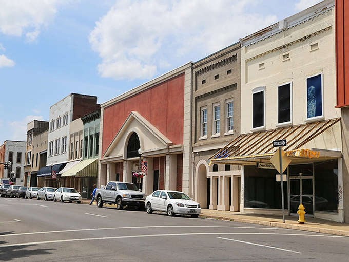 Historic buildings line streets where people still park and actually walk to shops instead of circling endlessly.