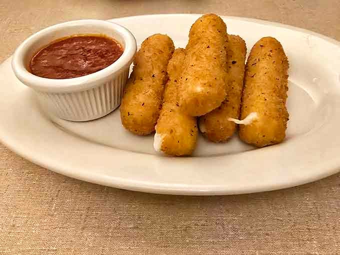 Golden mozzarella sticks proving that sometimes the simplest appetizers are the most dangerously addictive ones around.