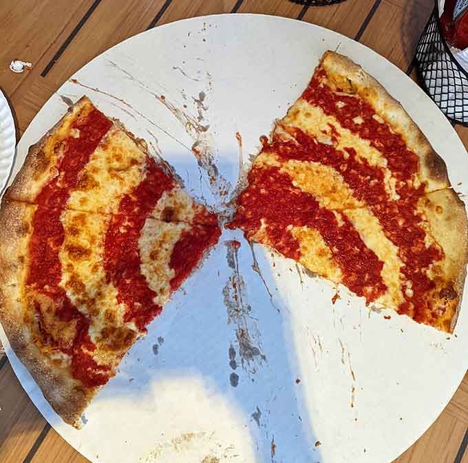 That signature tomato sauce swirl isn't just pretty, it's a promise of tangy, flavorful perfection in every bite.