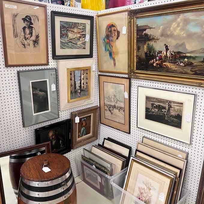 Wall art spanning generations, from pastoral scenes to portraits, each frame holding someone's carefully curated aesthetic.