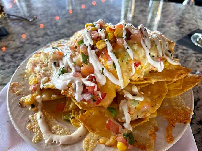 Nachos elevated to an art form with lobster, shrimp, and crab piled high like edible architecture.