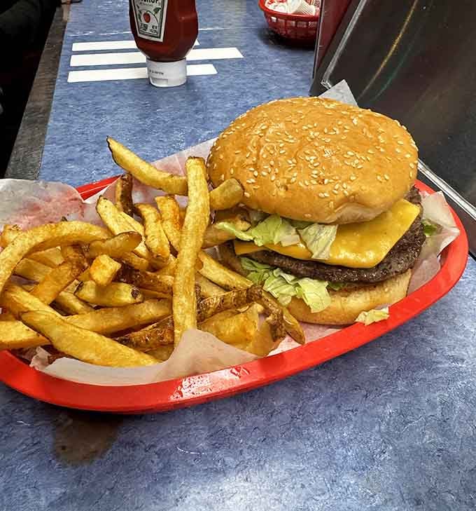 This towering burger with its sesame-studded bun and crispy fries proves that some architectural marvels don't need blueprints, just hunger.