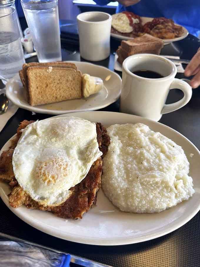 Turkey hash topped with perfectly cooked eggs alongside grits is comfort food that actually earns the title.