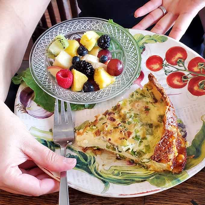 That slice of frittata paired with fresh fruit proves breakfast can be both virtuous and utterly satisfying at once.