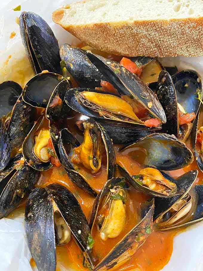 Plump mussels swimming in aromatic broth, served with crusty bread for the ultimate sopping experience.