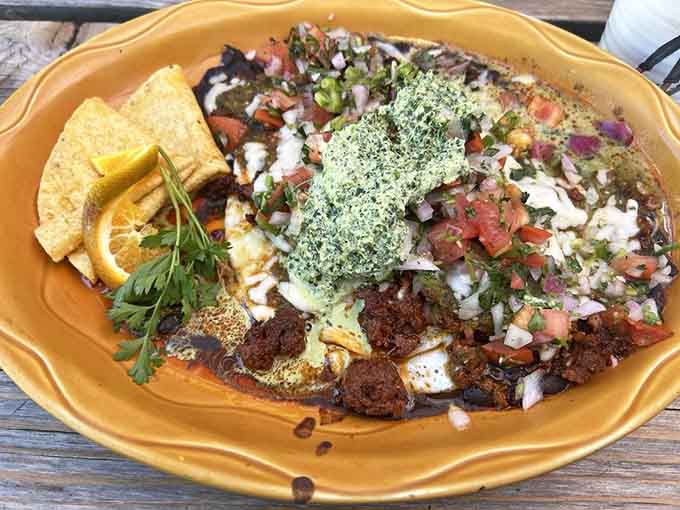 These huevos rancheros arrive looking like edible art, loaded with toppings that'll make your taste buds sing.