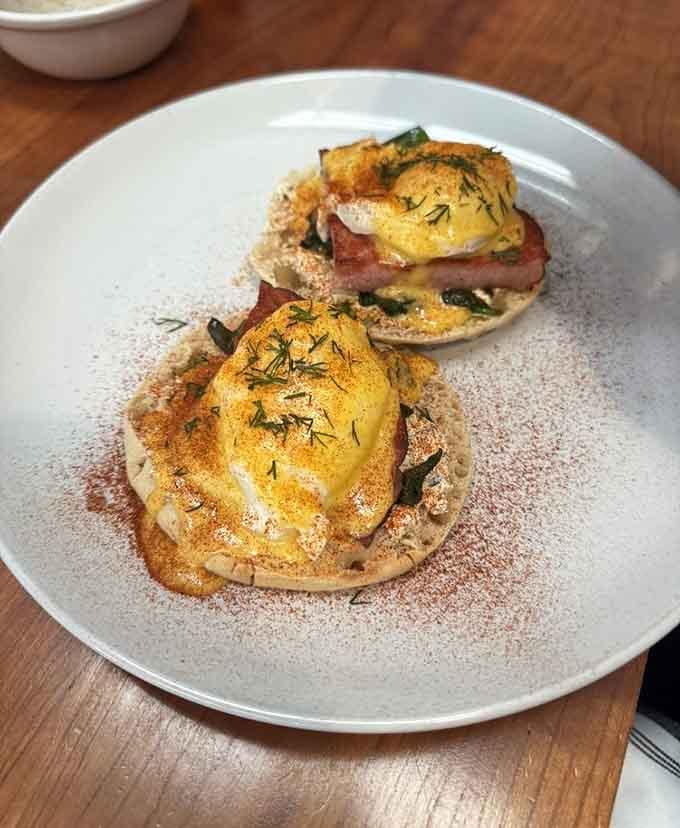 Eggs benedict done right, with hollandaise that doesn't quit and a presentation worthy of your Instagram feed's greatest hits.