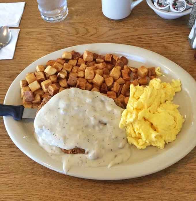 Golden chicken fried steak meets fluffy scrambled eggs and perfectly crisped potatoes in this breakfast masterpiece of epic proportions.