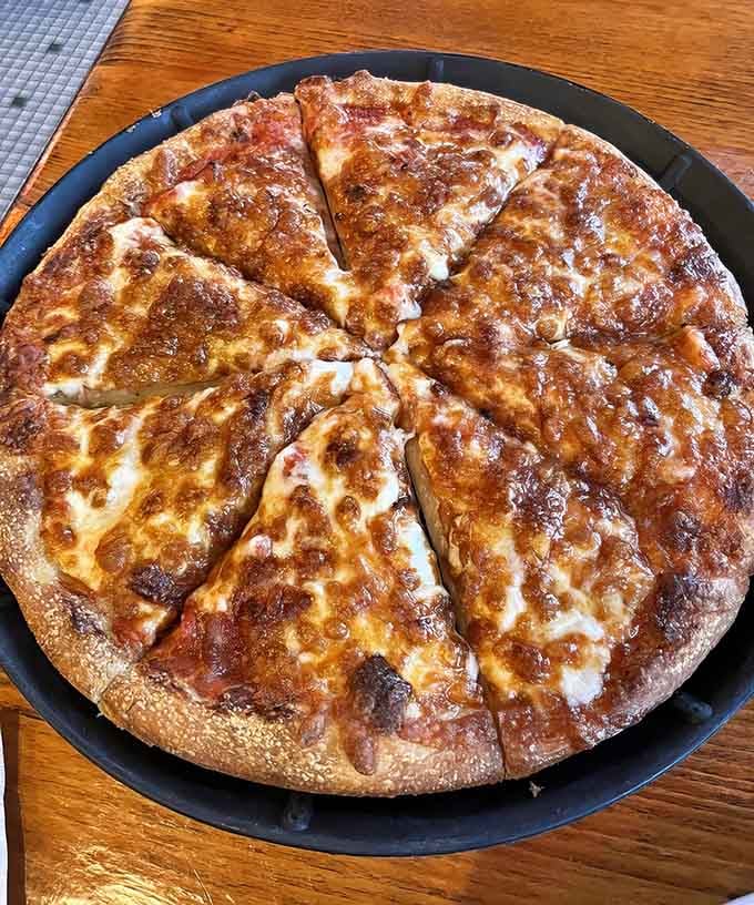 The perfectly charred bottom tells you everything you need to know about a kitchen that takes pizza seriously.