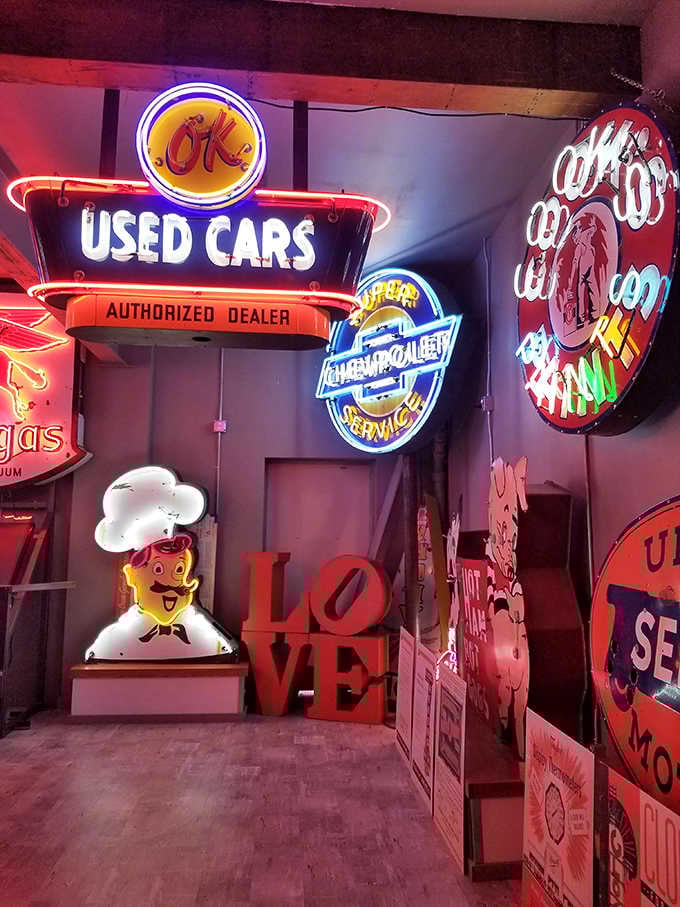 An entire wall of automotive nostalgia glows with the promise of used cars and authorized dealer dreams from another era.