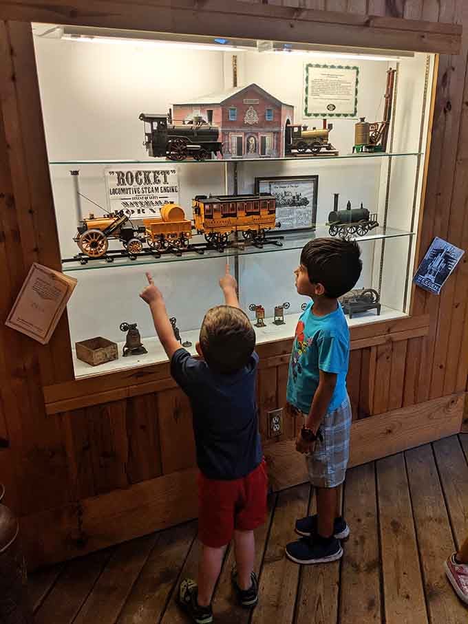 Young train enthusiasts discovering that history is way cooler than any video game when you can actually touch it.