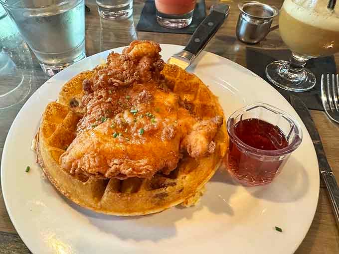 Fried chicken perched on a Belgian waffle like it's claiming its rightful throne in breakfast heaven.
