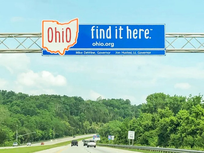 Highway signs guiding you through the Buckeye State, where every mile marker brings you closer to something worth discovering and experiencing.