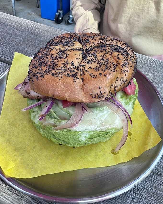 That poppy seed bagel is working overtime to contain what's clearly an ambitious amount of delicious filling.
