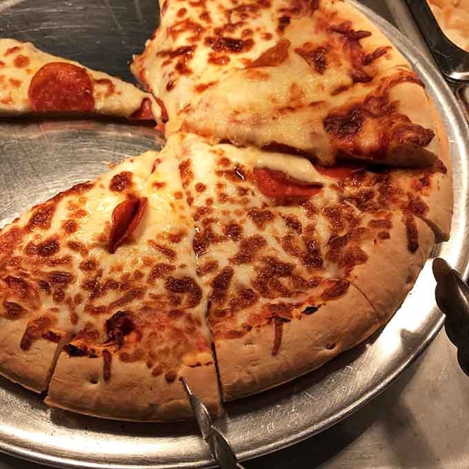 Pizza at an Asian buffet might seem unexpected, but life's too short to question delicious cross-cultural collaborations like this.