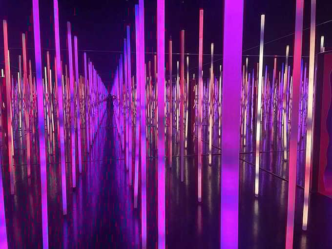 A forest of glowing pillars stretches endlessly, making you feel wonderfully tiny and amazed.