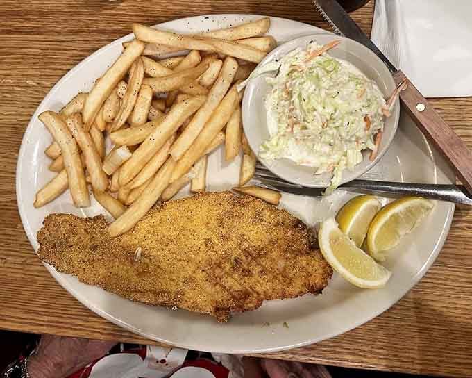 That catfish is so perfectly fried it could teach a masterclass on achieving the ideal golden crust.