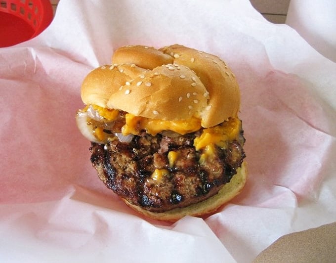 Melted cheddar cascades over char-grilled beef, creating a masterpiece Michelangelo would've painted if he'd been hungrier.