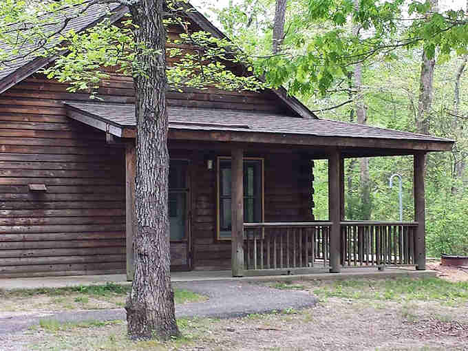 Rustic cabins nestled in the woods offer nature with a roof, the perfect compromise for civilized camping.