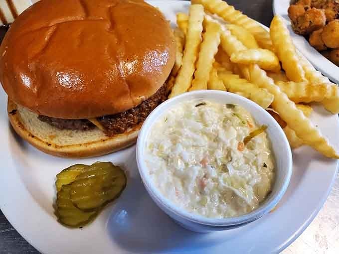 The classic combo: burger, coleslaw, and fries that prove sometimes the old ways are the best ways.